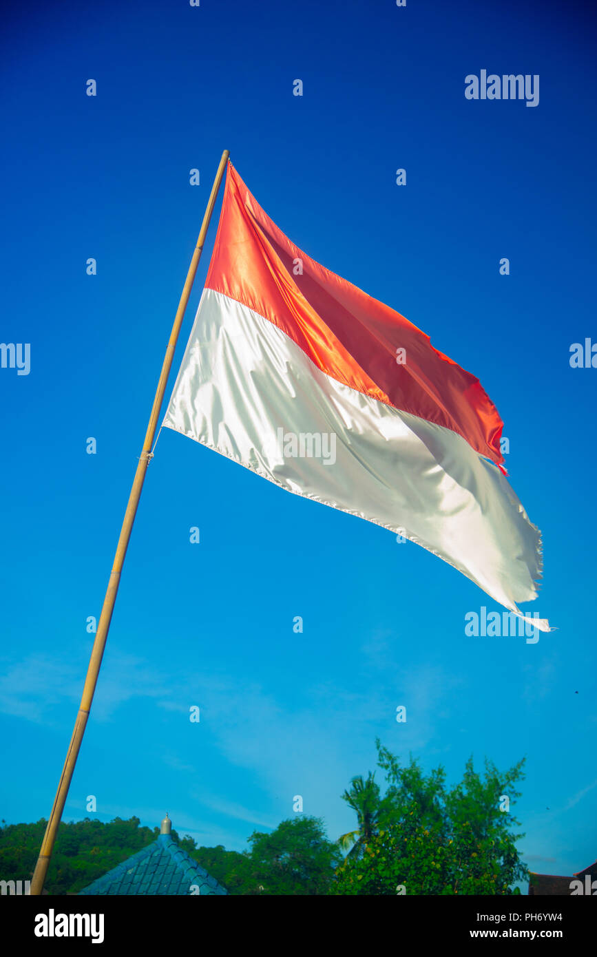 Indonesian Flag nearby the ocean in Bali, Indonesia. Bali is an ...