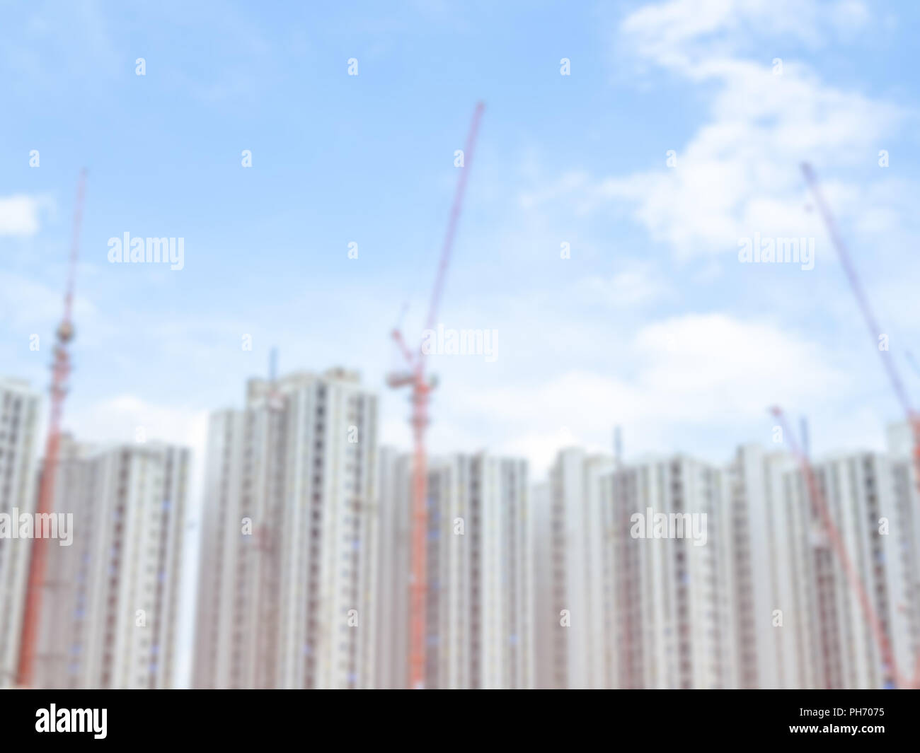 Blurred building construction site and crane with cloud and blue sky ...