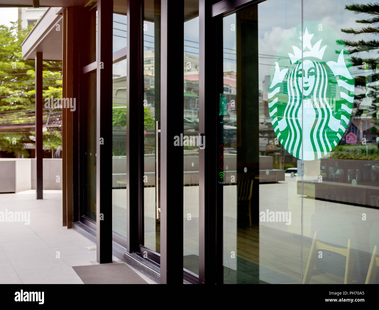 BANGKOK, THAILAND - August 18, 2018: Starbucks sign inside door behind ...