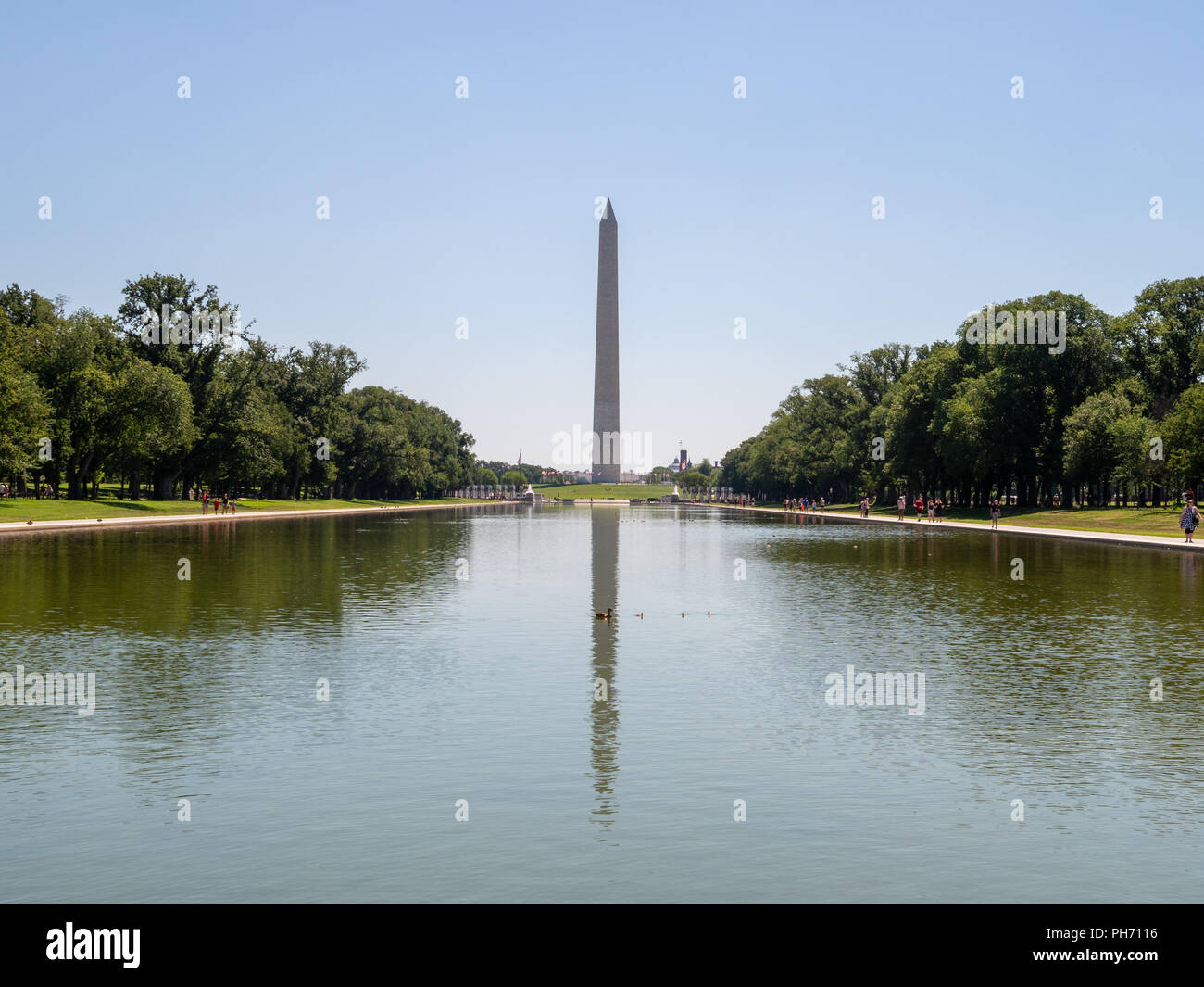 Washington Monument in front of the reflecting pool on National Mall on ...