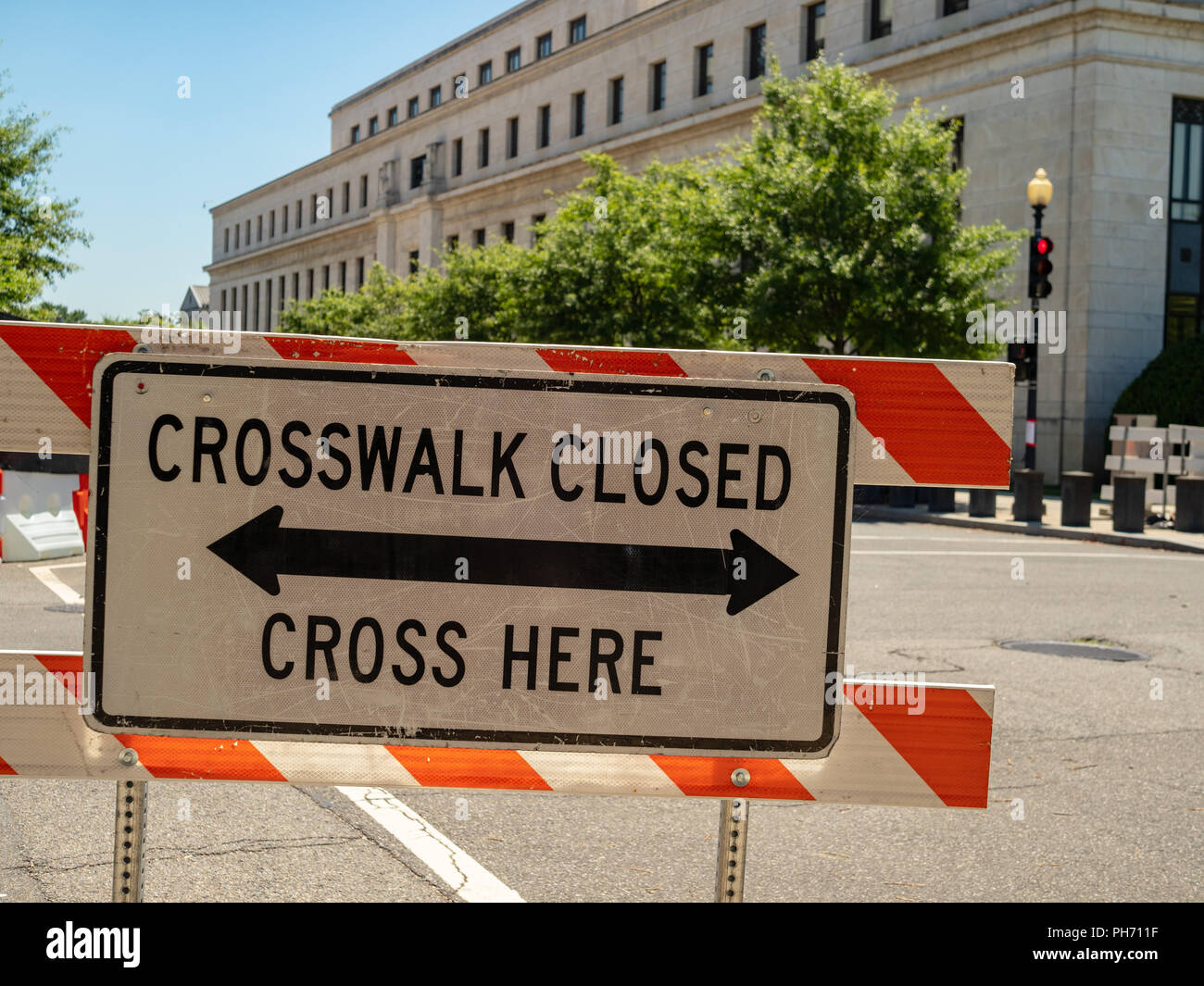 A crosswalk closed, cross here sign in front of intersection Stock ...