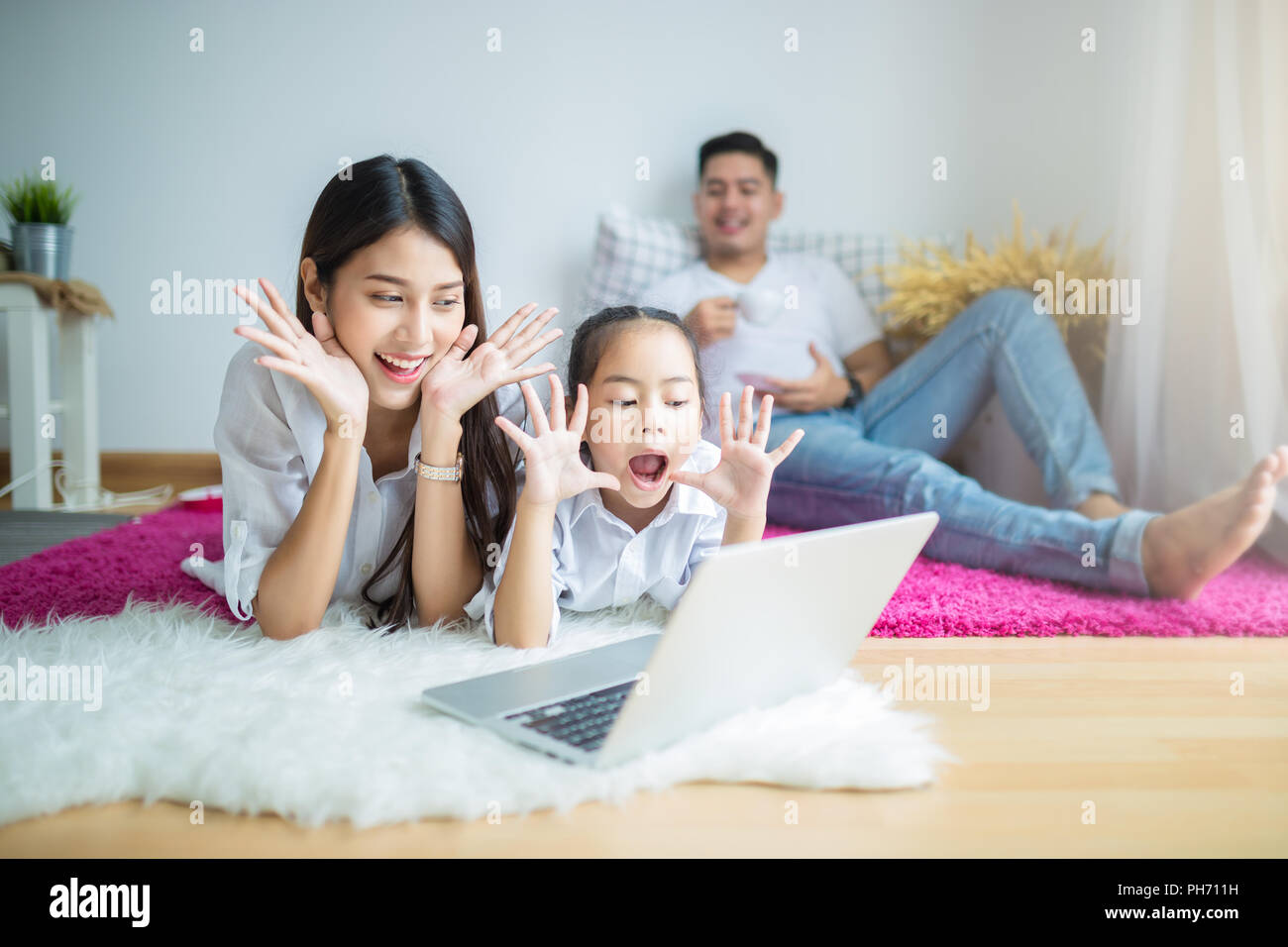 happy family mother, father, child daughter play laptop computer at ...
