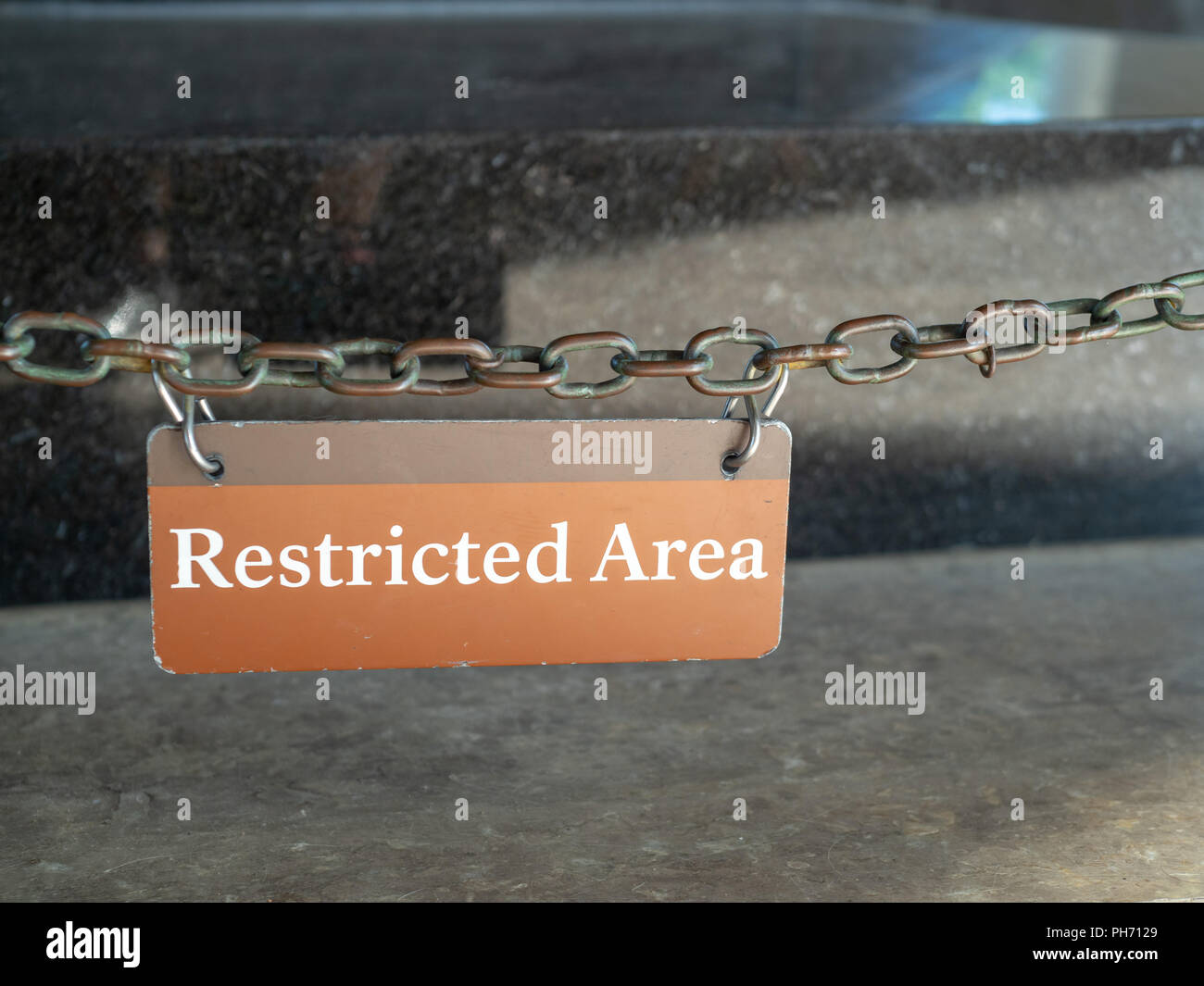 Restricted area sign hanging in front of a protected area Stock Photo ...