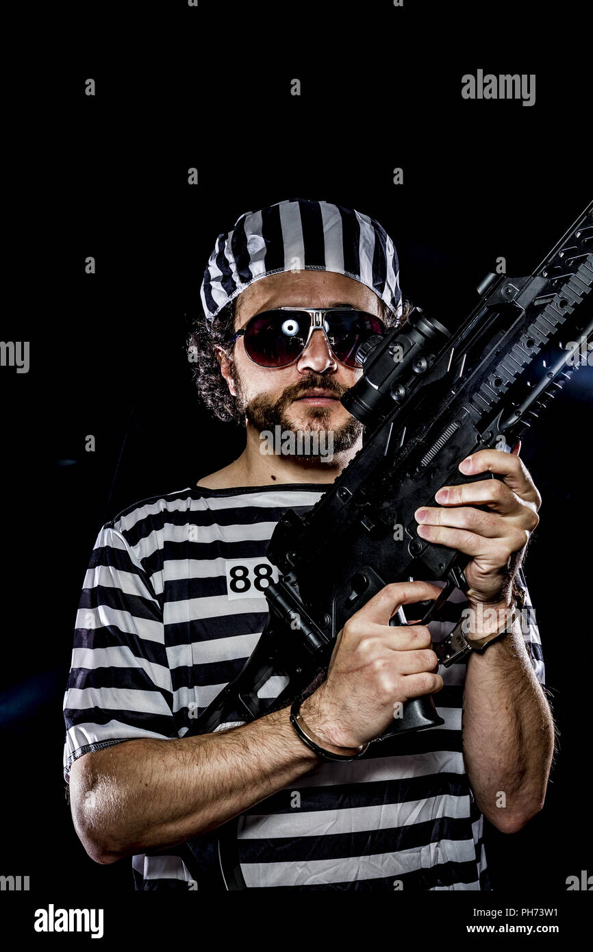 Security.Prison riot concept. Man holding a machine gun, prisoner Stock ...
