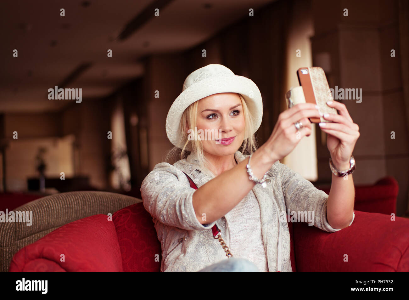 Smiling woman taking mobile selfie hi-res stock photography and images ...