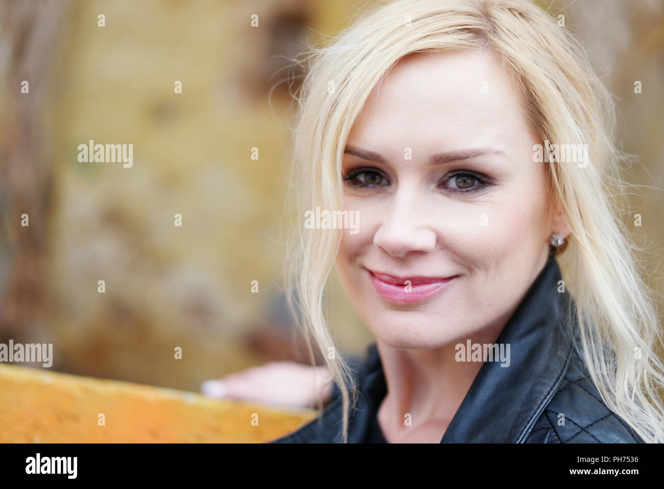 Gorgeous Blond Woman Leaning on the Wall Stock Photo - Alamy