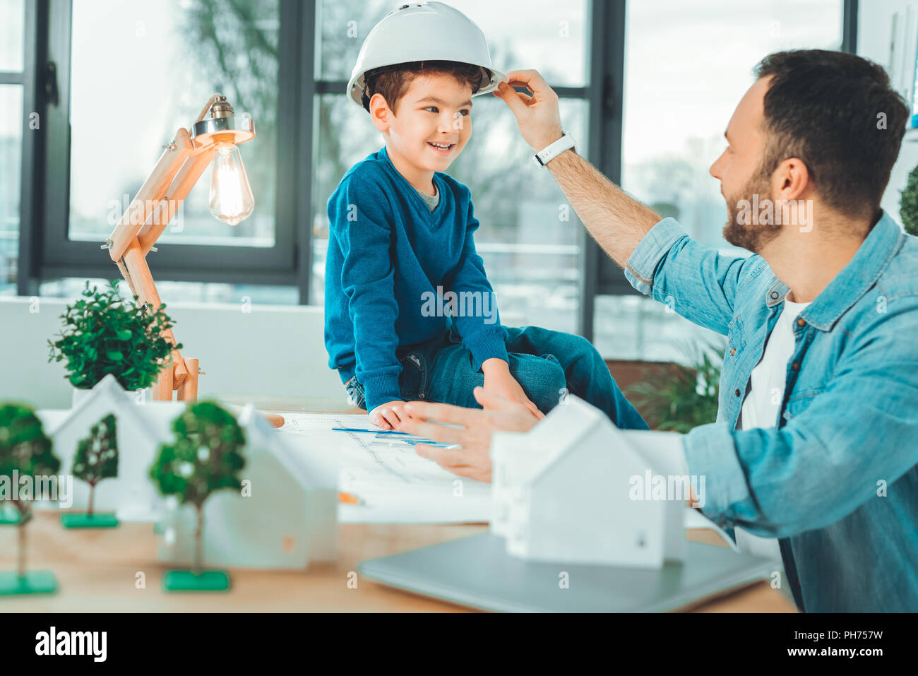Cheerful child being at work with daddy Stock Photo - Alamy