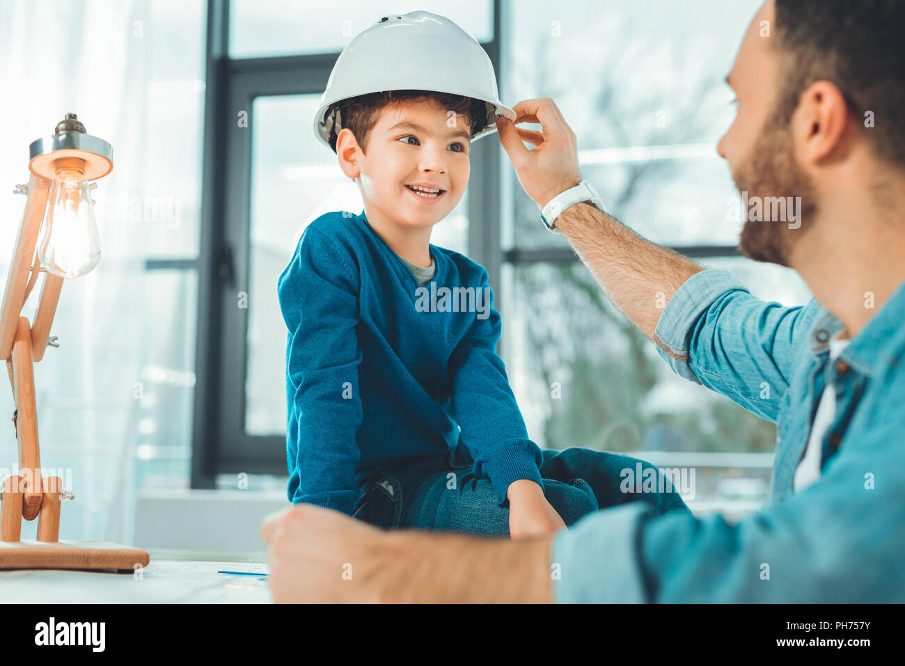 Joyful brunette kid looking at his father Stock Photo - Alamy