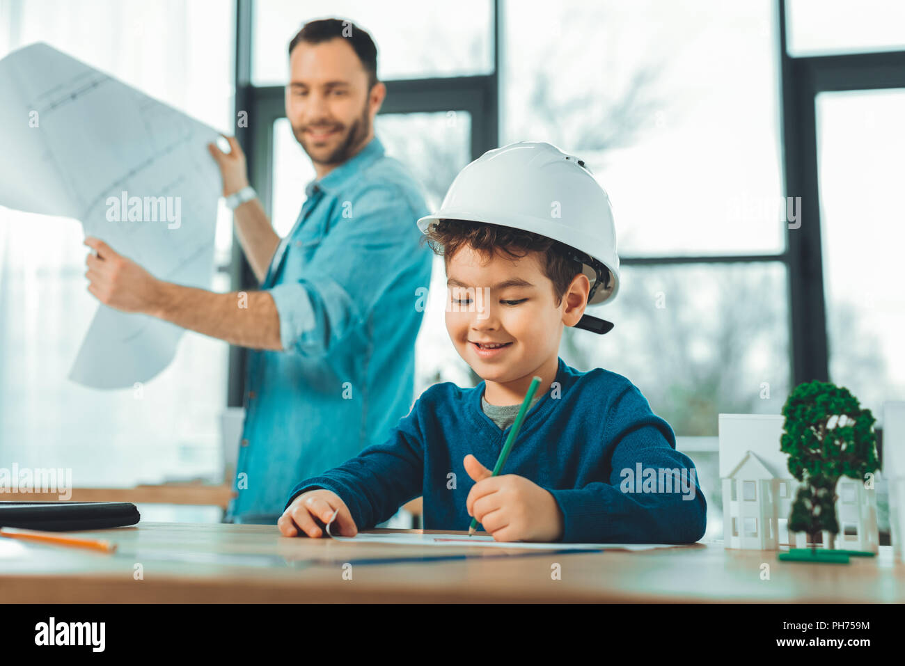 Positive delighted kid drawing picture Stock Photo - Alamy