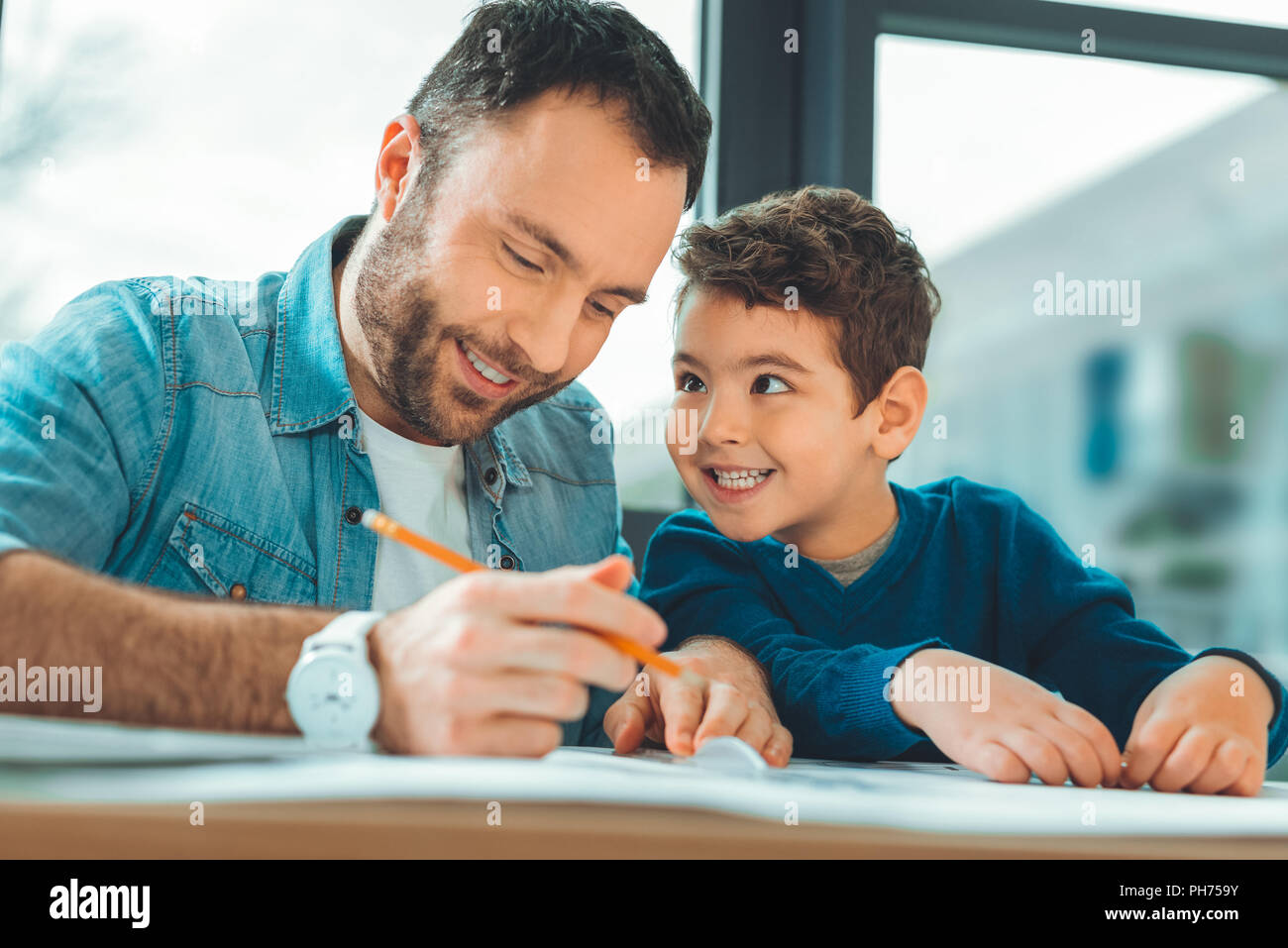 Playful kid staring at his father Stock Photo - Alamy
