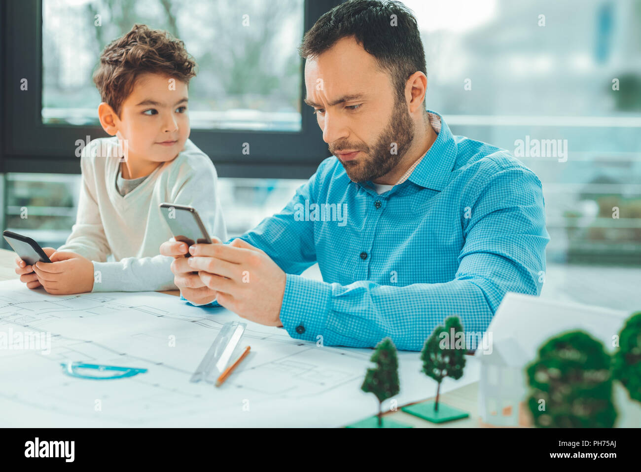 Serious young man reading message Stock Photo - Alamy