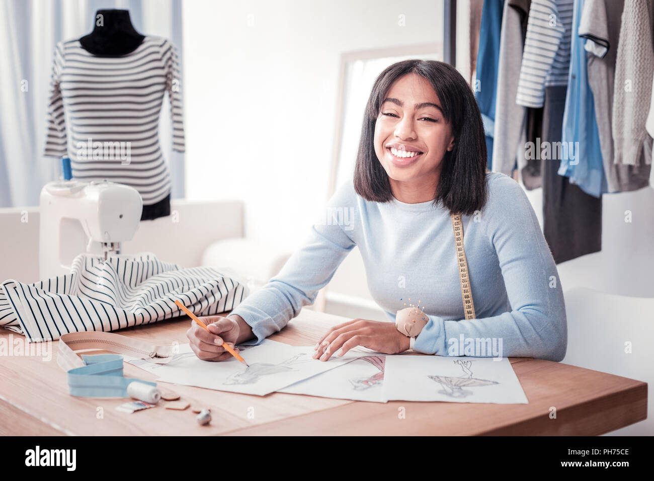 Professional cheerful tailor drawing models for coming collection Stock ...