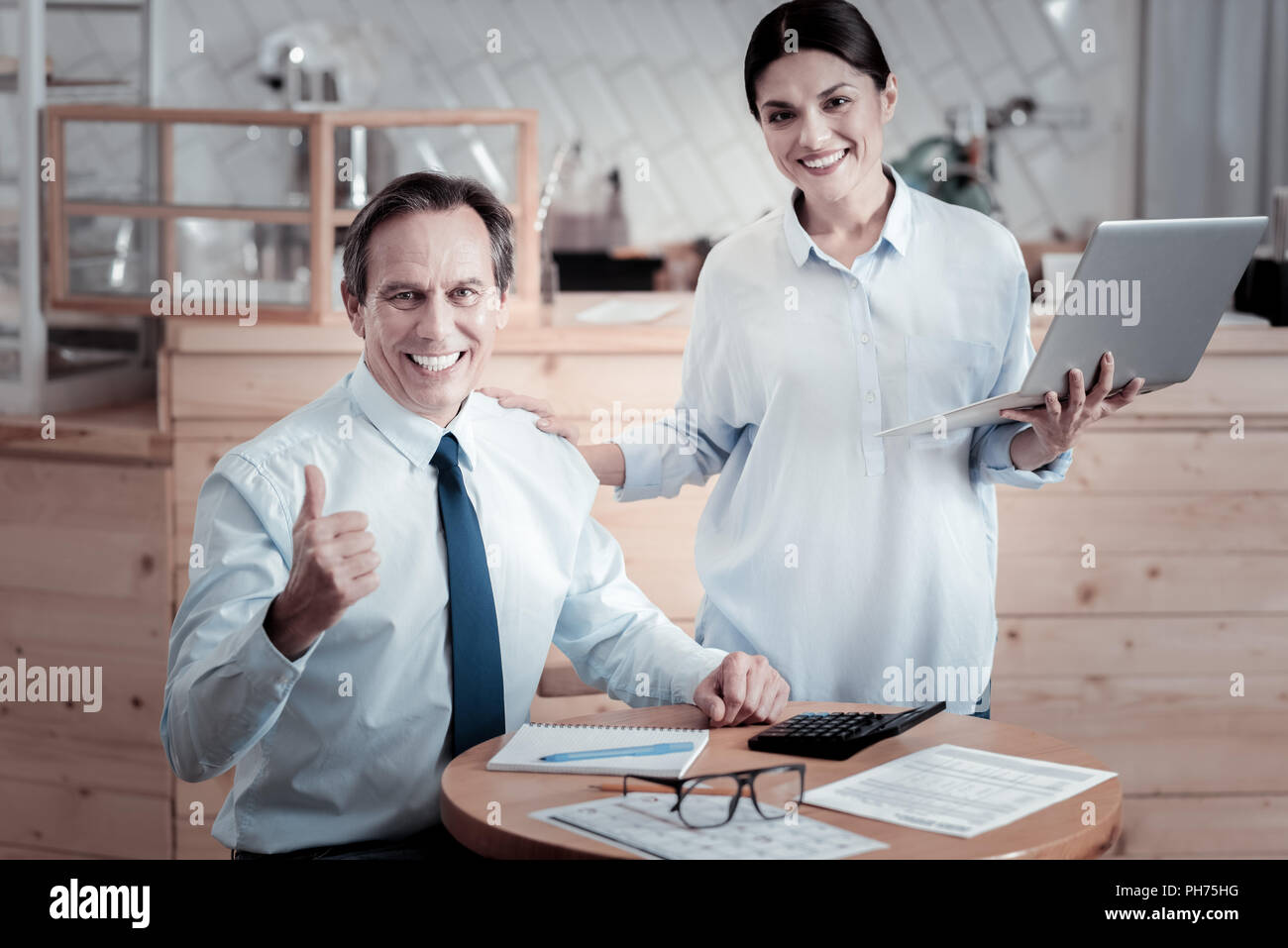 Cheerful entrepreneurs smiling and feeling ready for work Stock Photo ...