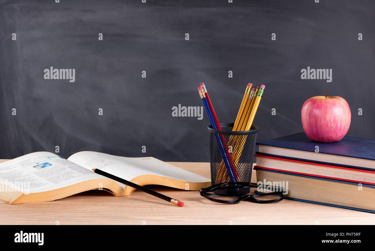 Desktop in classroom ready to learn from textbooks Stock Photo - Alamy