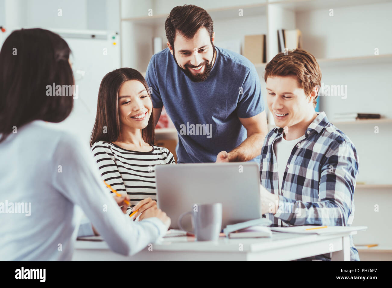 Joyful young students discussing their project Stock Photo - Alamy