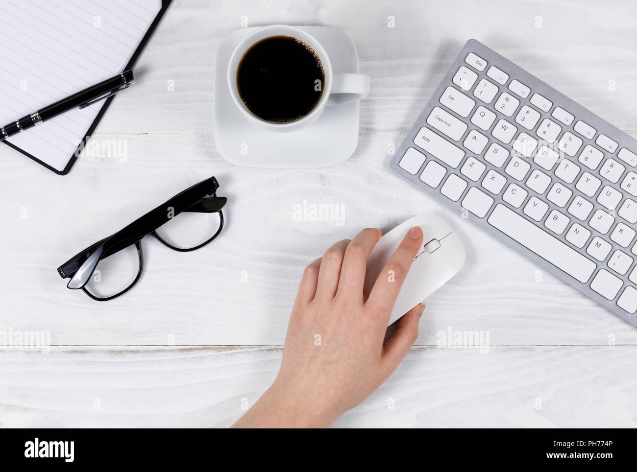 Female hand using computer mouse on organized white desktop Stock Photo ...