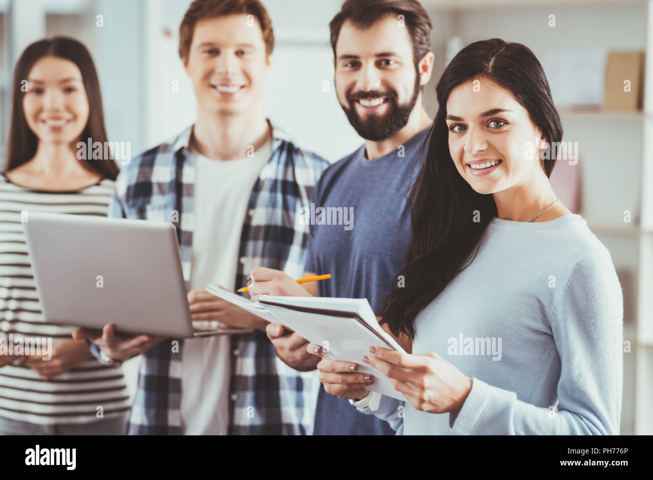 Delighted nice woman taking notes Stock Photo - Alamy