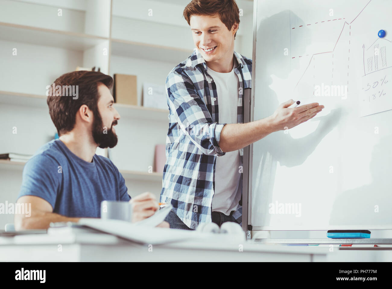 Nice young man presenting his plan Stock Photo - Alamy Nice young man presenting his plan Stock Photo - Alamy