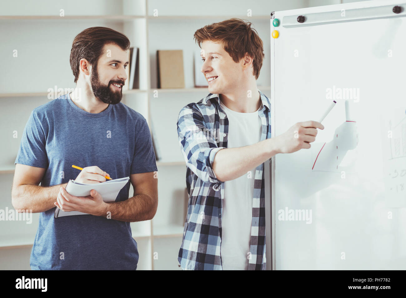 Smart young men looking at each other Stock Photo - Alamy