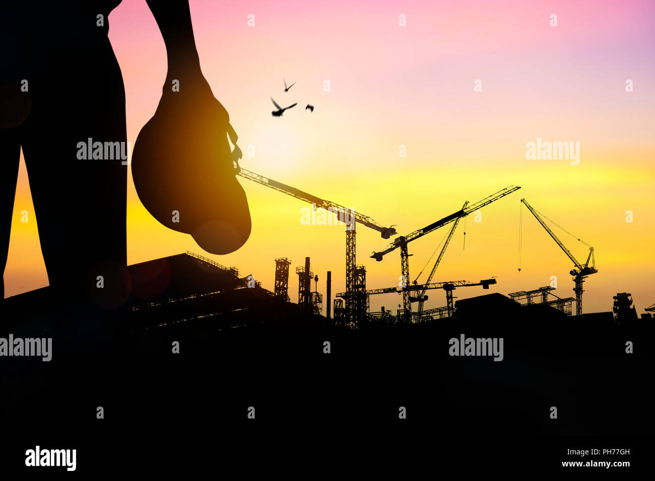 Silhouette engineer standing after overtime with building construction ...