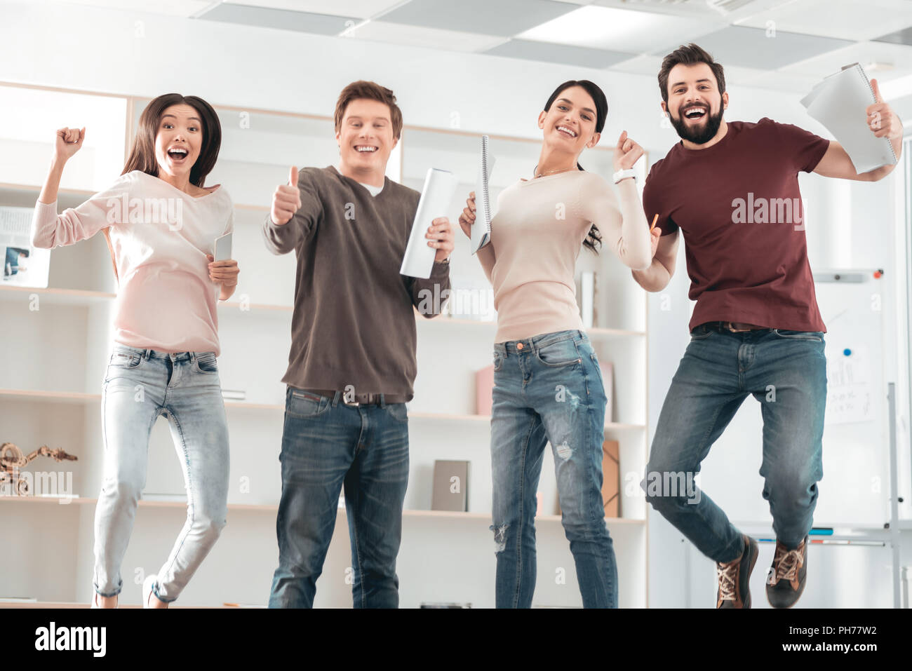 Delighted happy people jumping Stock Photo - Alamy