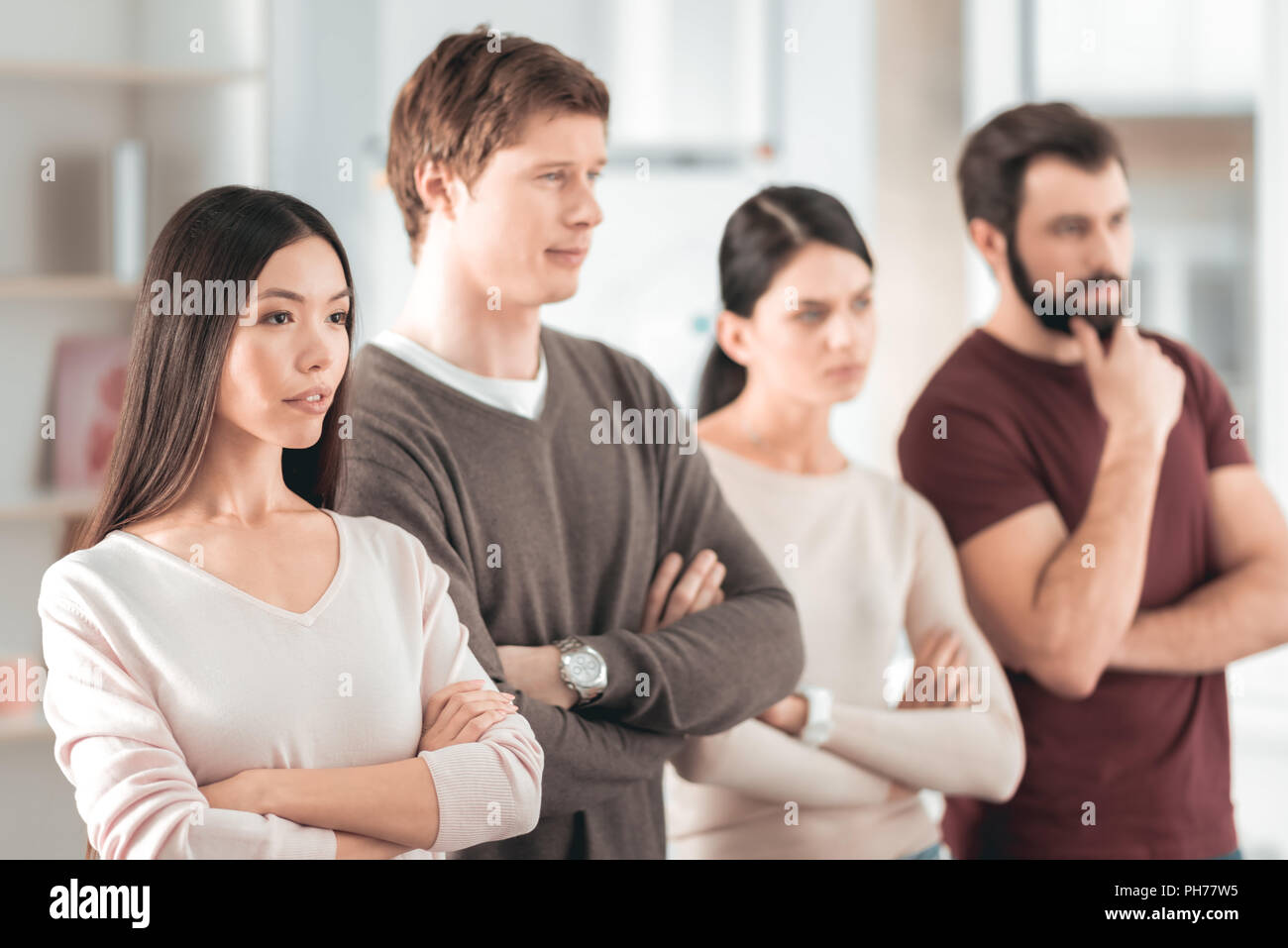 Serious young people standing together Stock Photo - Alamy