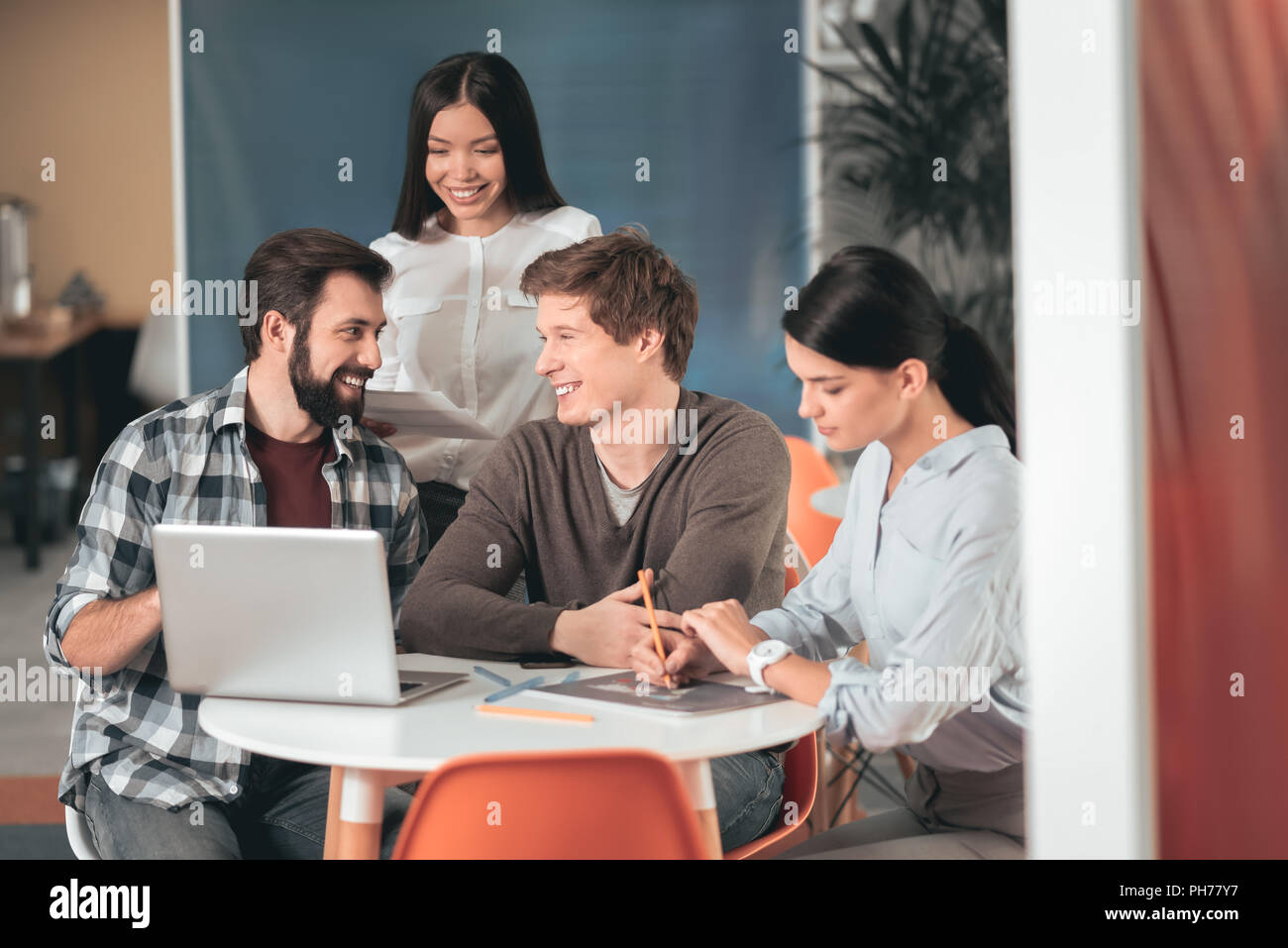 Joyful happy students talking to each other Stock Photo - Alamy