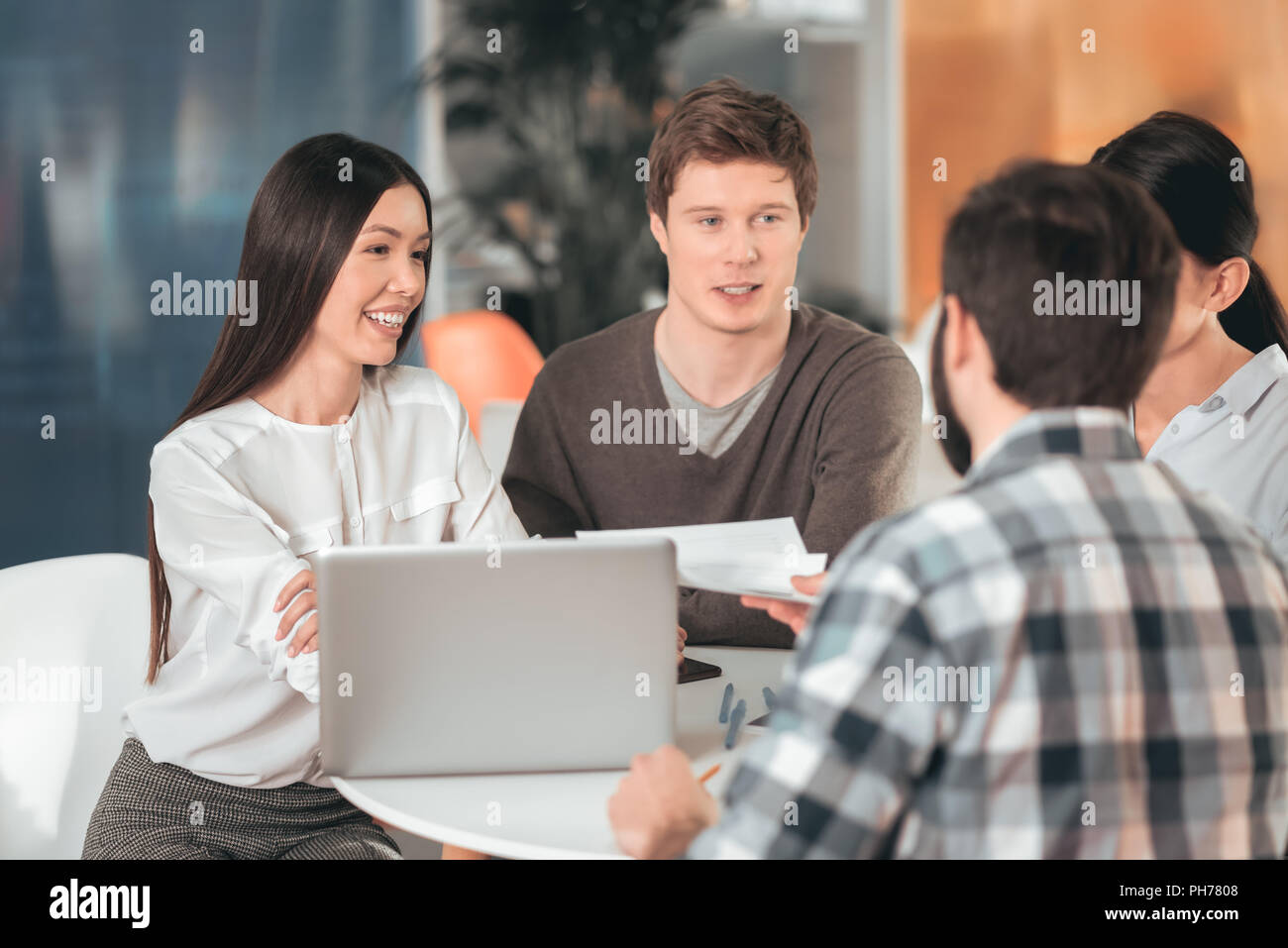 Happy joyful people sharing their ideas Stock Photo - Alamy