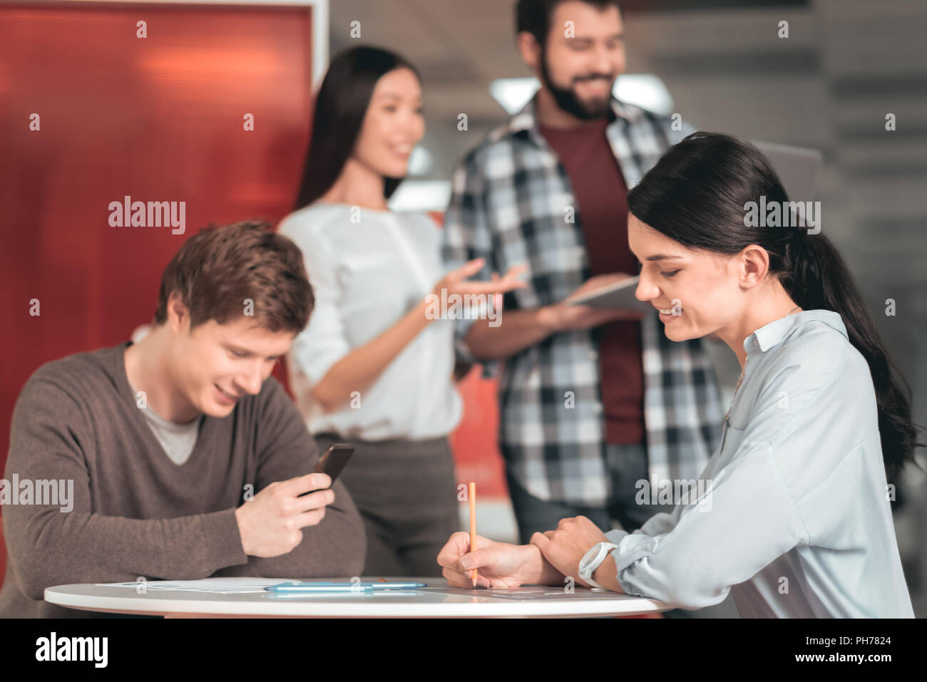 Joyful young woman taking notes Stock Photo - Alamy