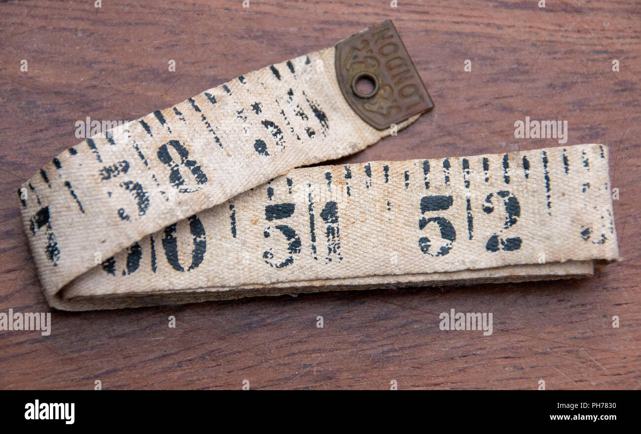 A close up view of a folded white vintage measuring tape Stock Photo ...