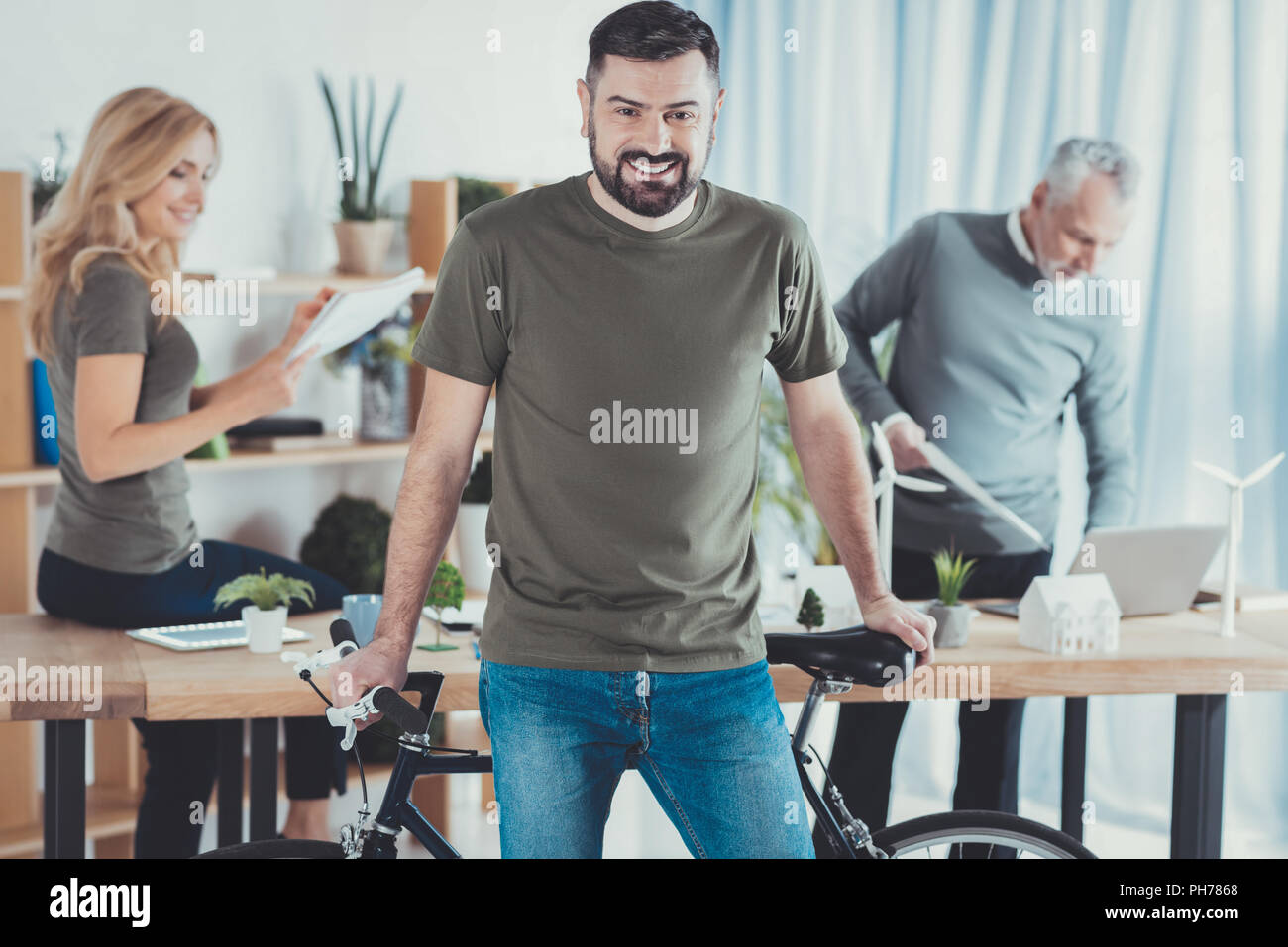Jolly male colleague coming to work Stock Photo - Alamy