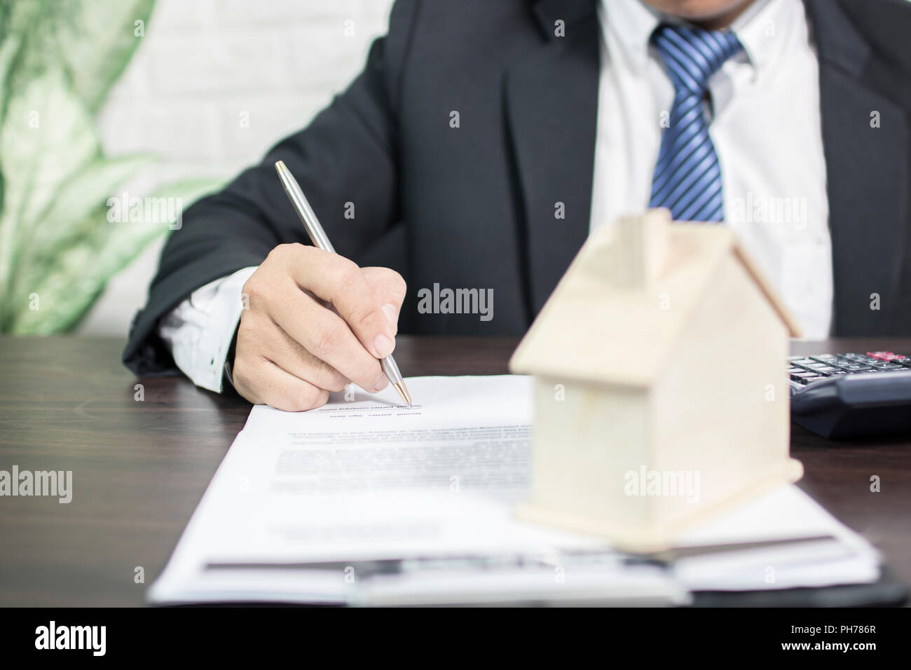 Bank officer sign contract for approving house finance Stock Photo - Alamy