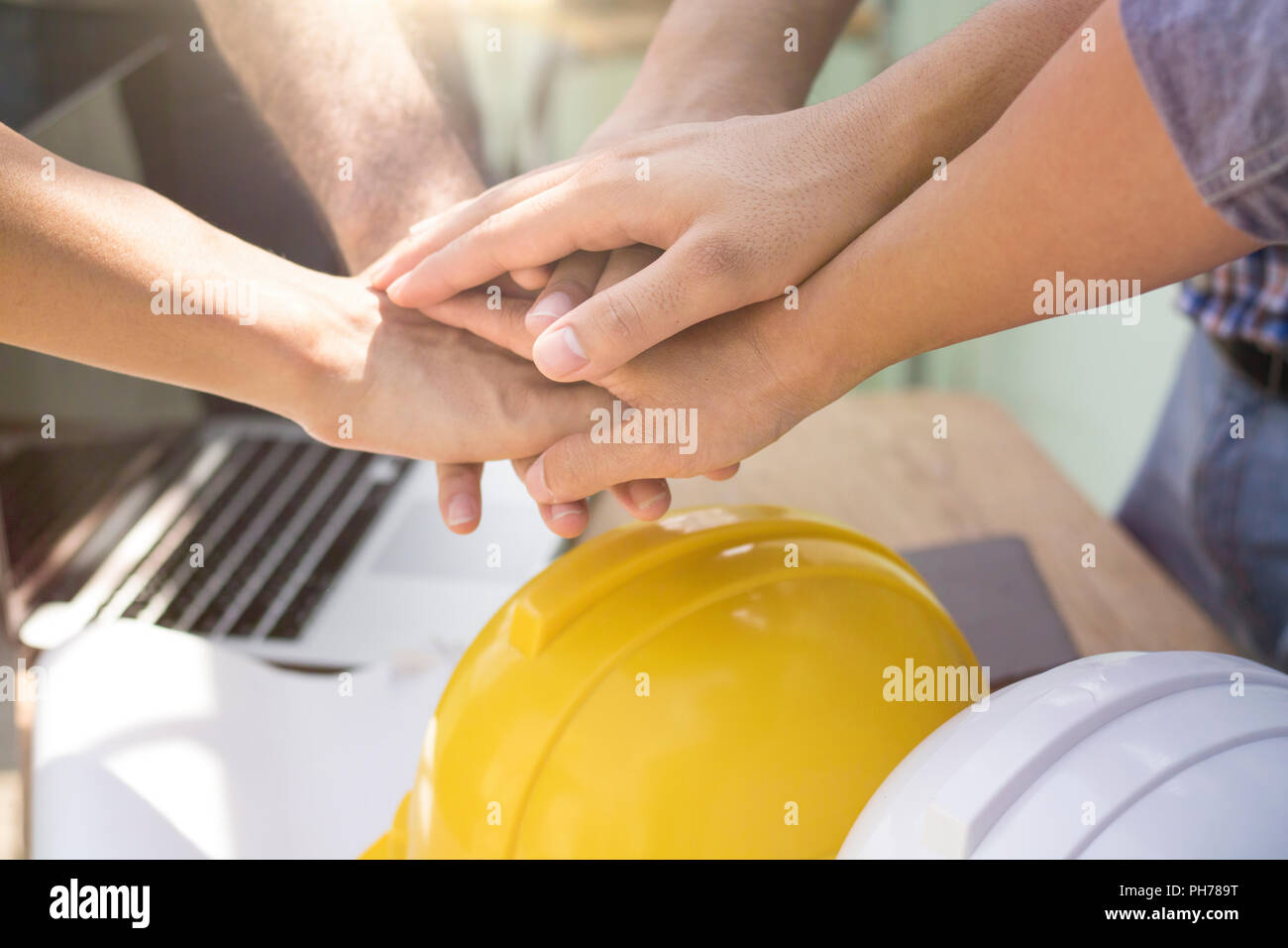 teamwork concept engineers and worker put hand on together on working ...