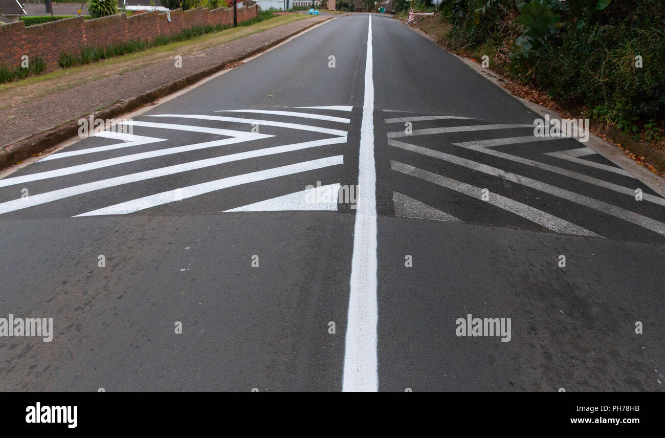 A front view of a speed bump one side newly painted and the other to ...