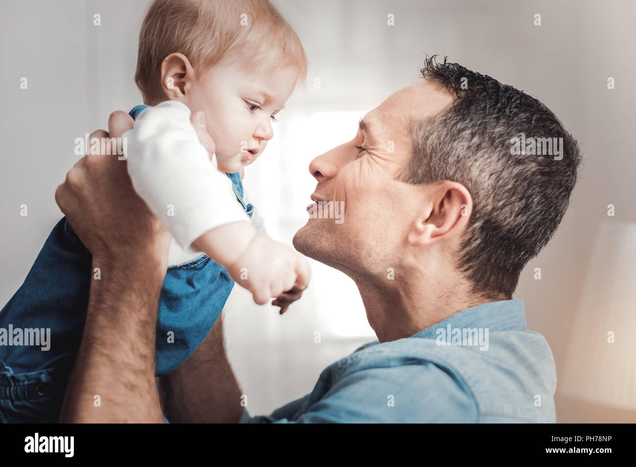 Cute happy child looking at his father Stock Photo - Alamy