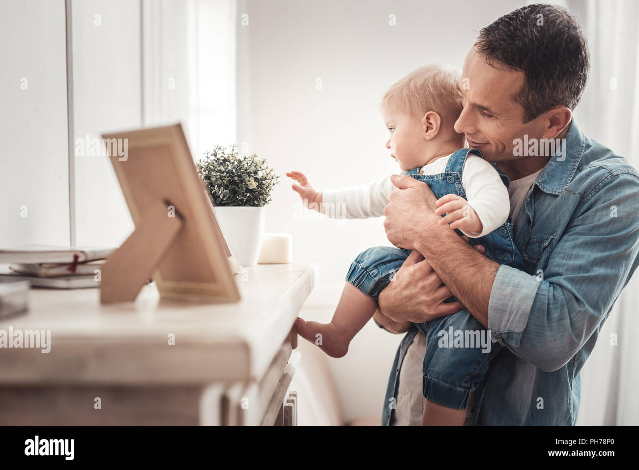 Cute small child touching a plant Stock Photo - Alamy