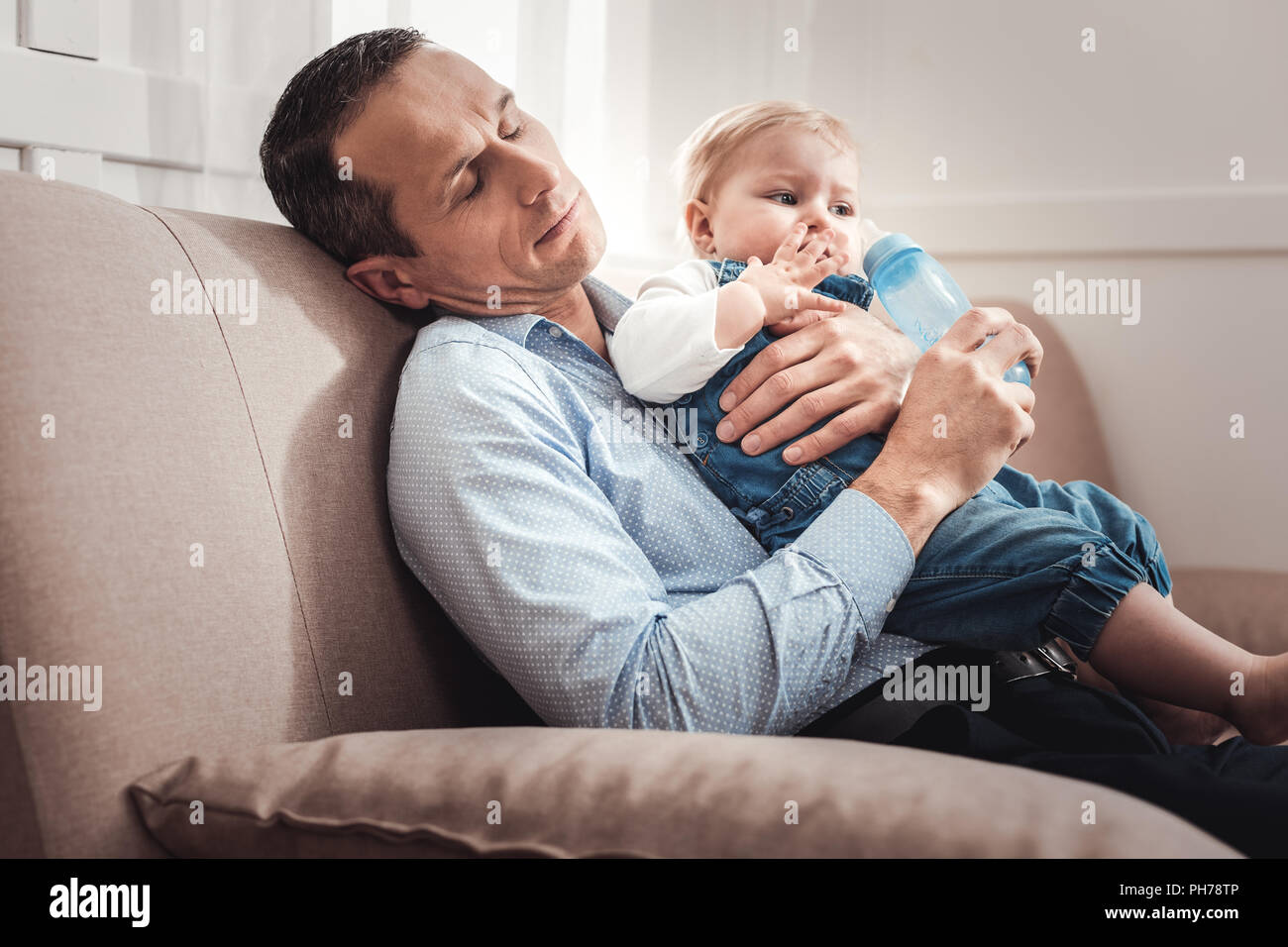 Nice tired man falling asleep Stock Photo - Alamy