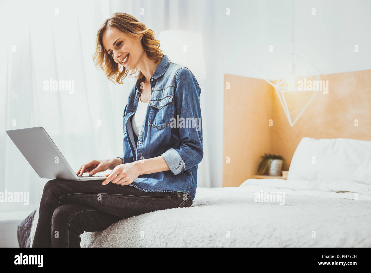 Interesting female staring into screen Stock Photo - Alamy
