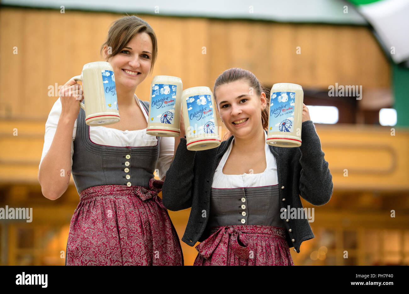 Germany, Munich. 30th Aug, 2018. Two waitress present the official ...