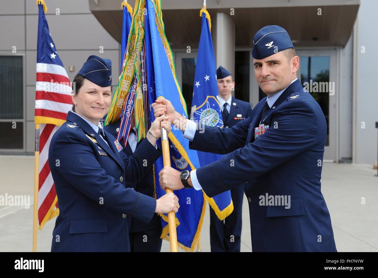 Col. Jennifer Grant, commander of the 50th Space Wing, hands the 50th ...