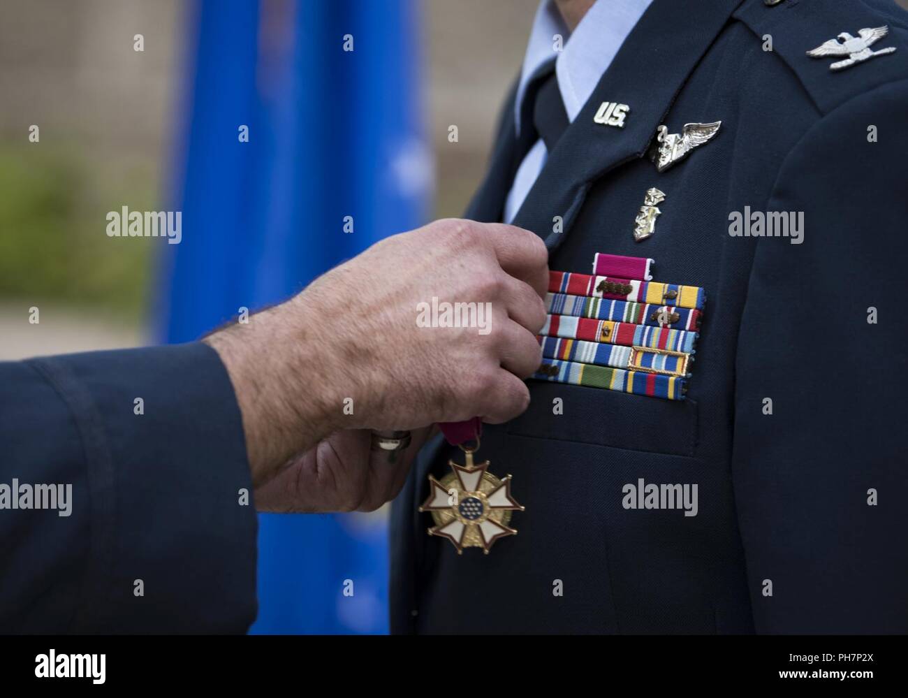 Col. Cavan Craddock, 99th Air Base Wing commander, awards a Legion of ...