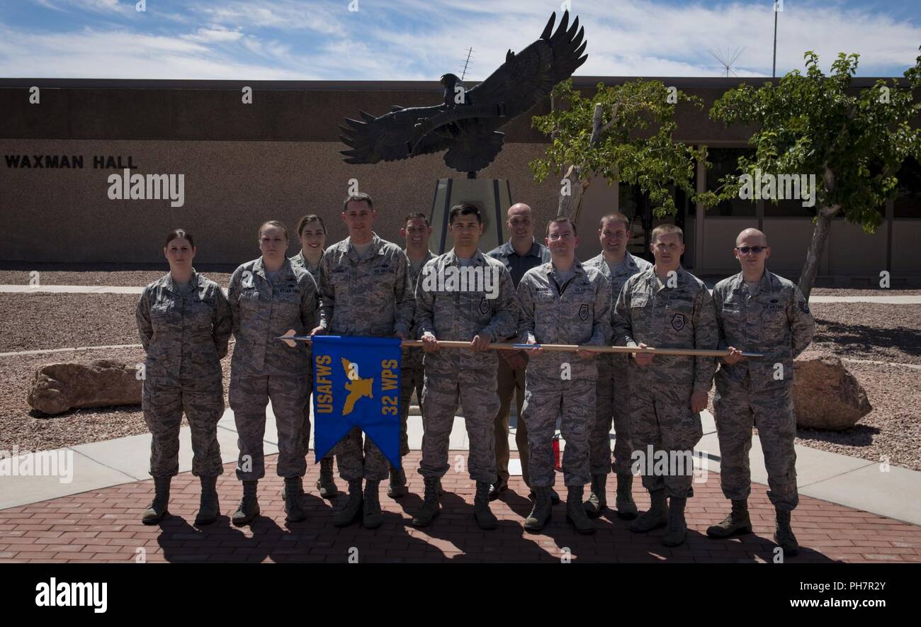 Members assigned to the 32nd Weapons Squadron stand in front of the U.S ...