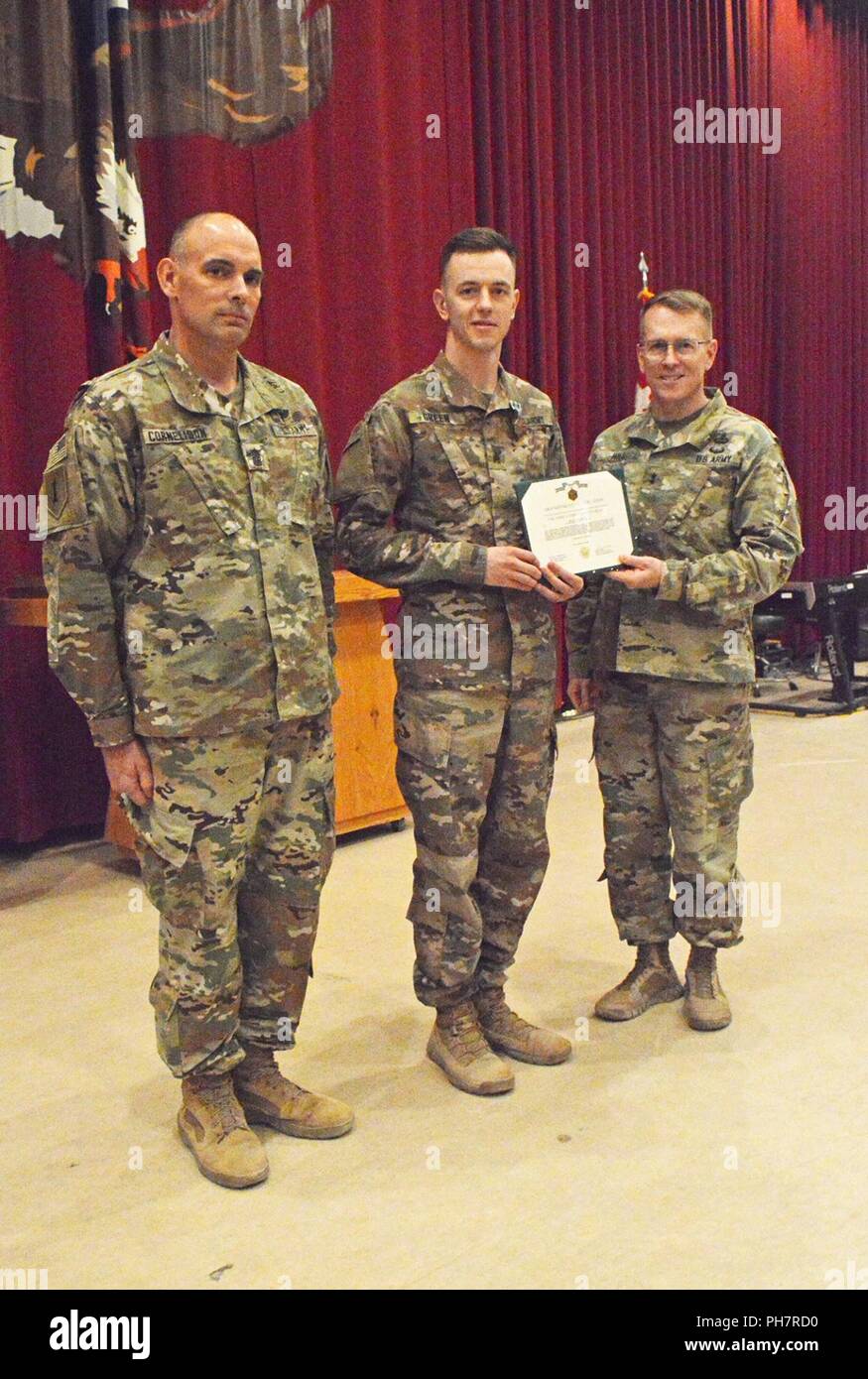 38th Sustainment Brigade Soldier Sgt. Zachary Green accepts his award ...