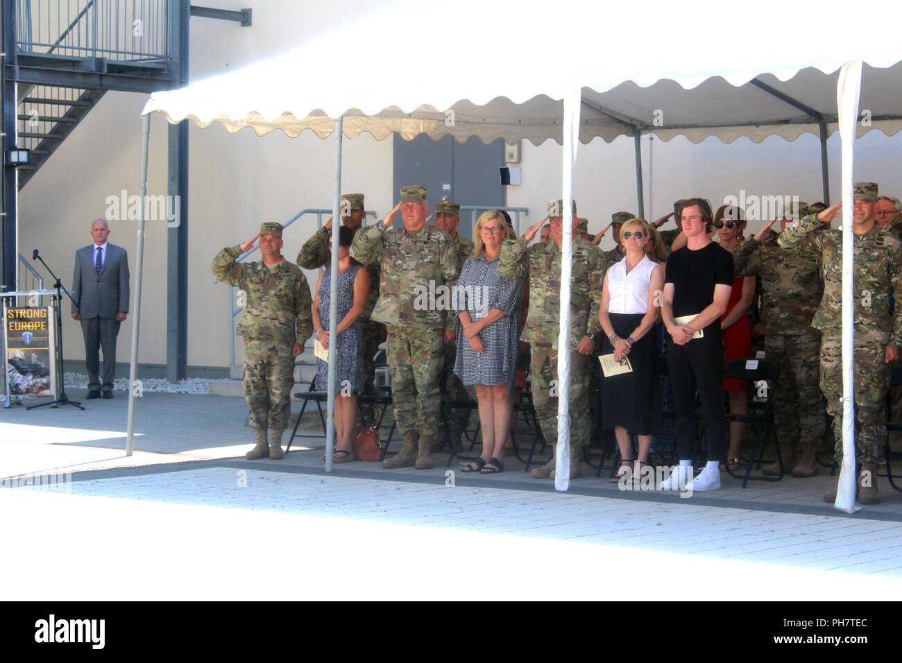Members of the official party render salutes while the National Anthem ...