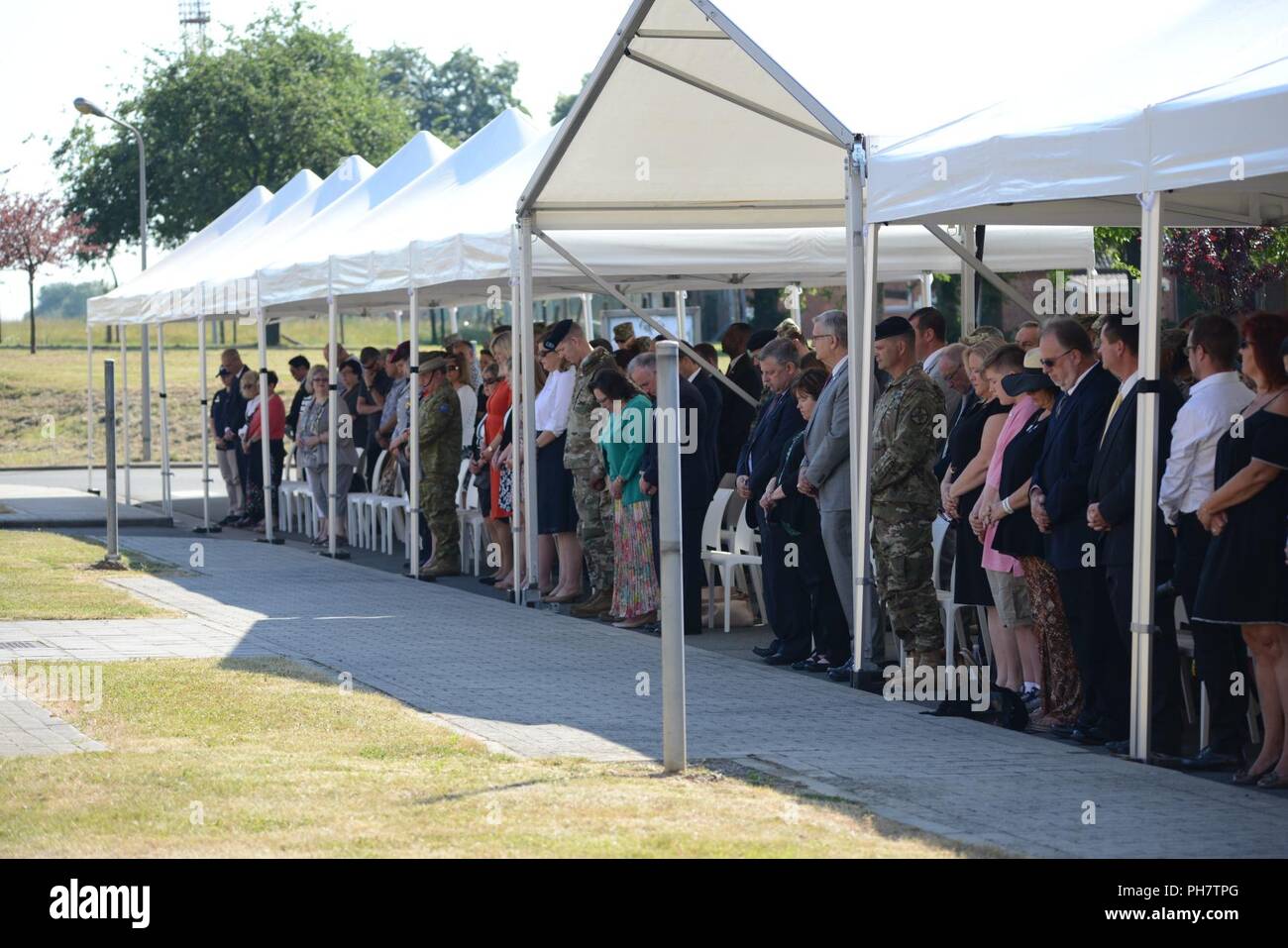 Multinational Soldiers and civilian employees, stand at attention for ...