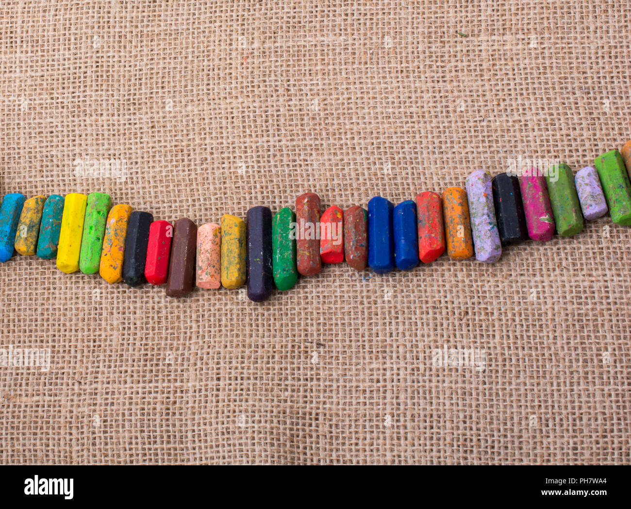 Toddlers hand putting crayons in line on canvas Stock Photo - Alamy