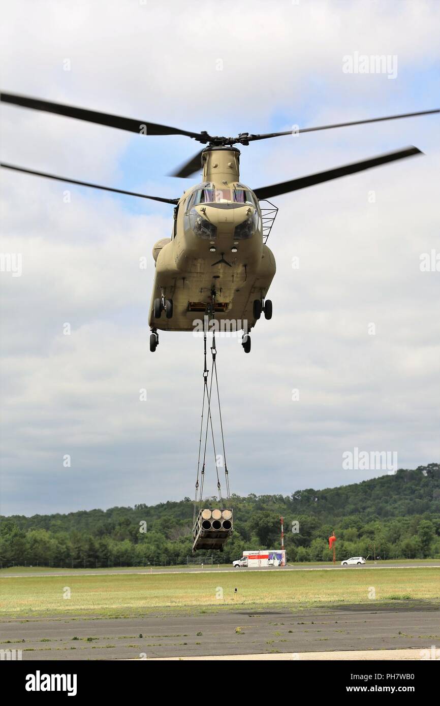 An aircrew of a Chinook helicopter picks up a mock ammunition pallet ...