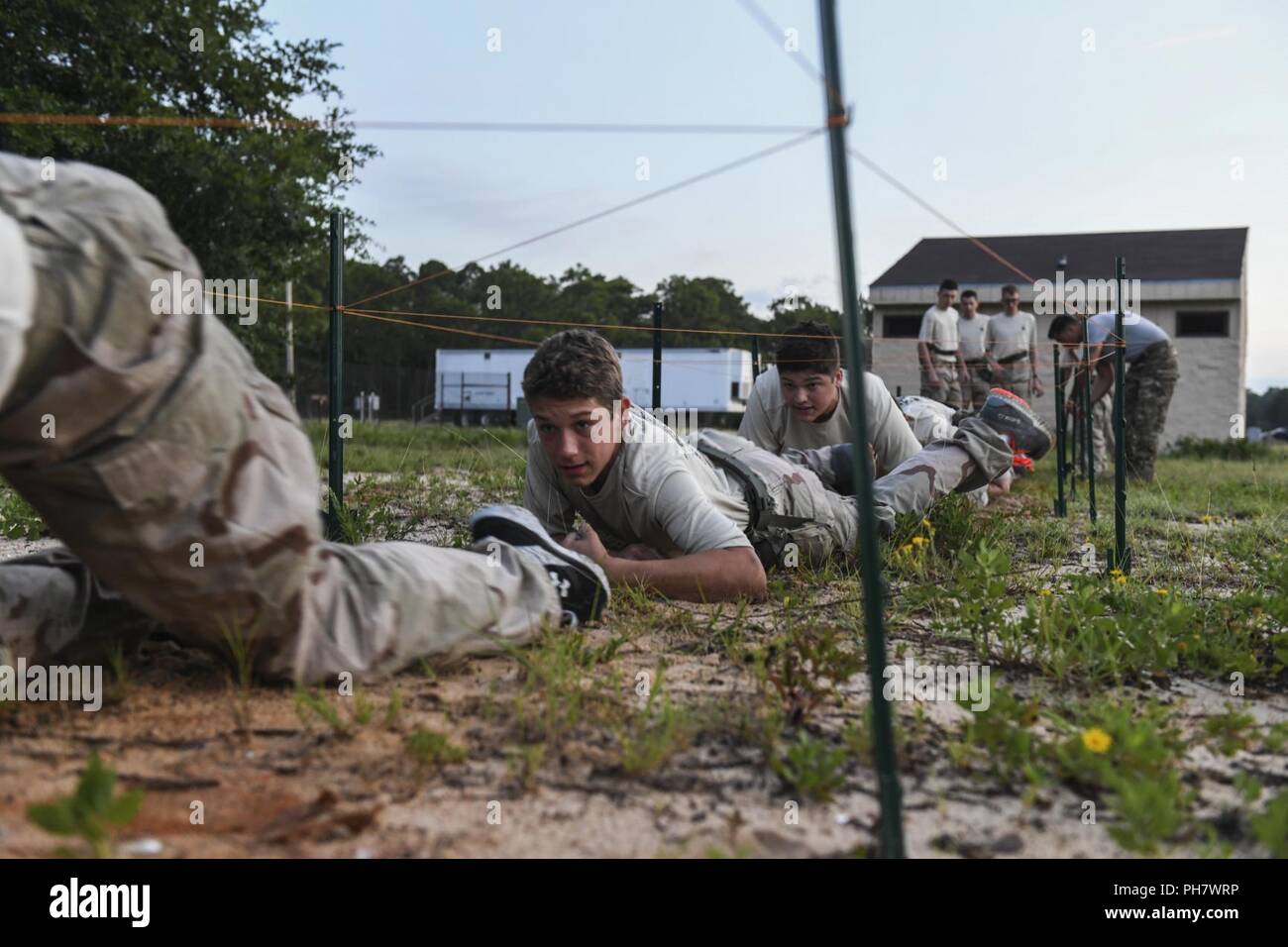 Junior ROTC cadets Army crawl under an obstacle during a Monster Mash ...