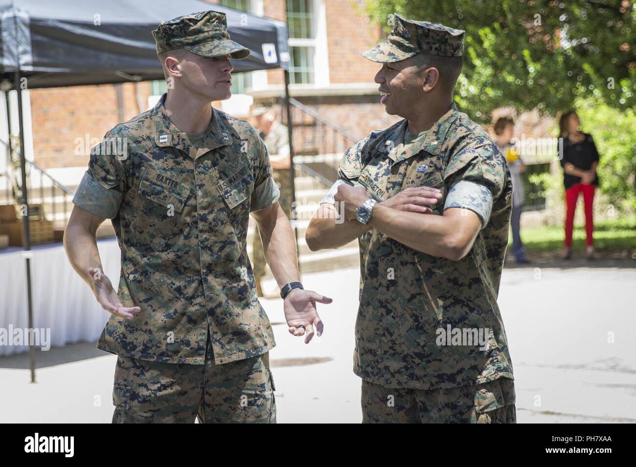 U.S. Marine Corps Capt. William Baxter, left, commanding officer ...