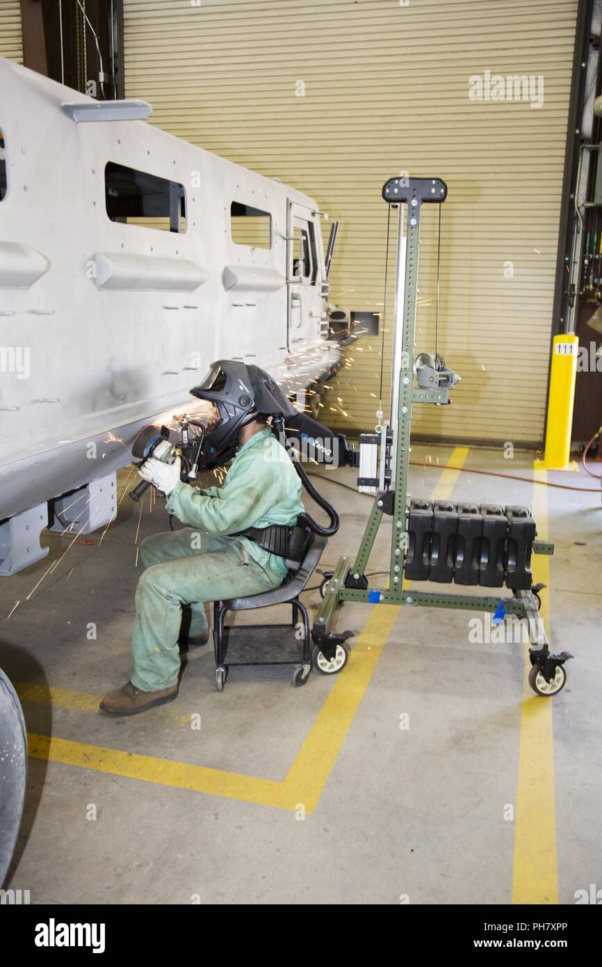 Niels Woods, welder, uses a grinder attached to an Ekso Zero Gravity ...